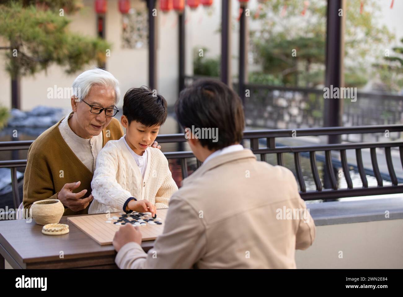 Male Members of the Family Playing Go Stock Photo - Alamy