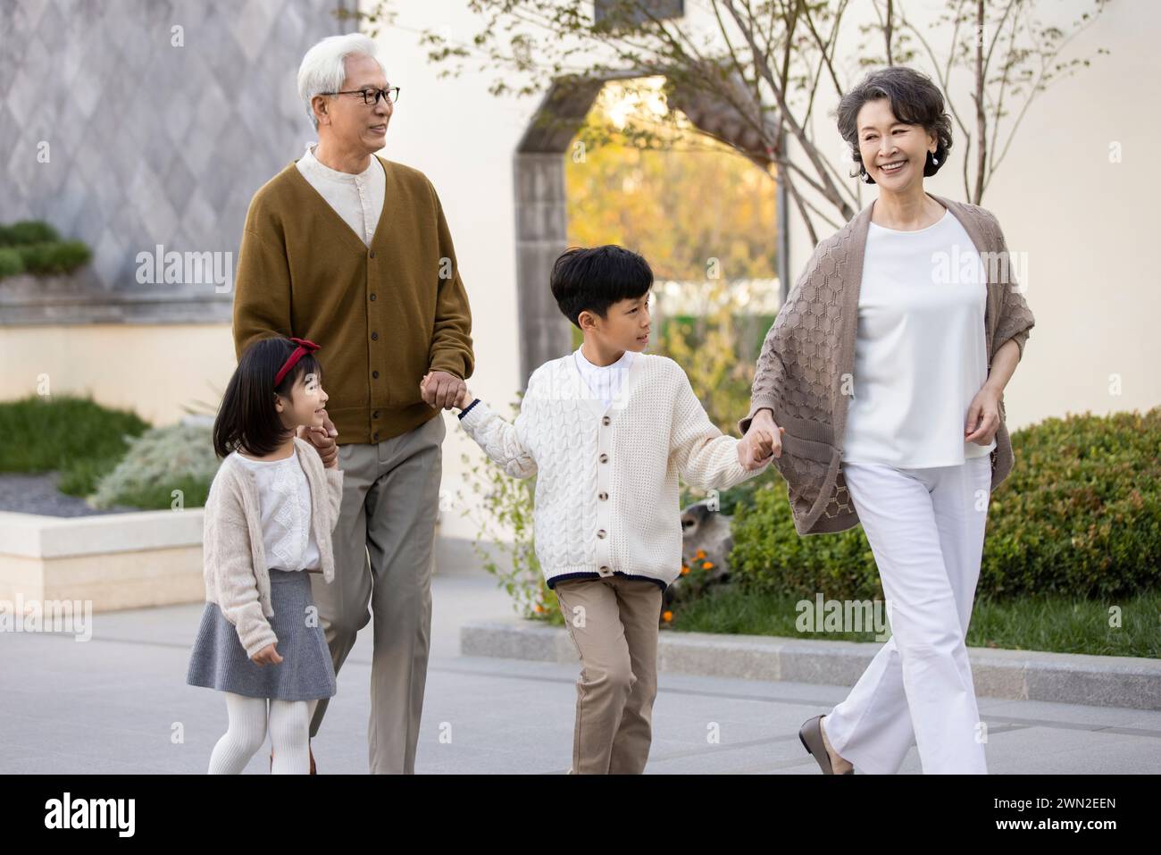 Grandparents and Grandkids Taking a Walk in Park Stock Photo - Alamy