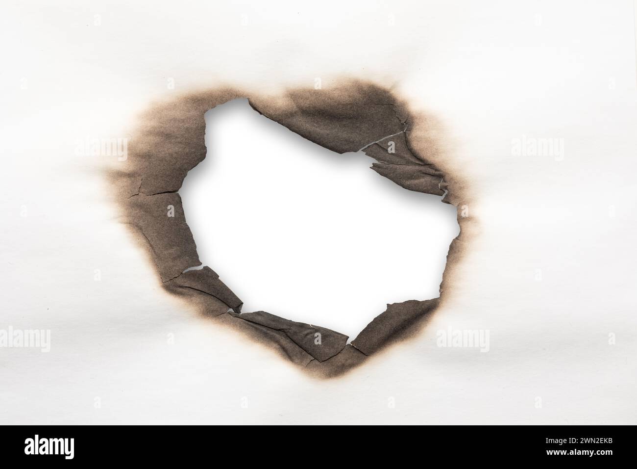 Burnt Hole in a Piece of Paper Isolated on a White Background Stock ...