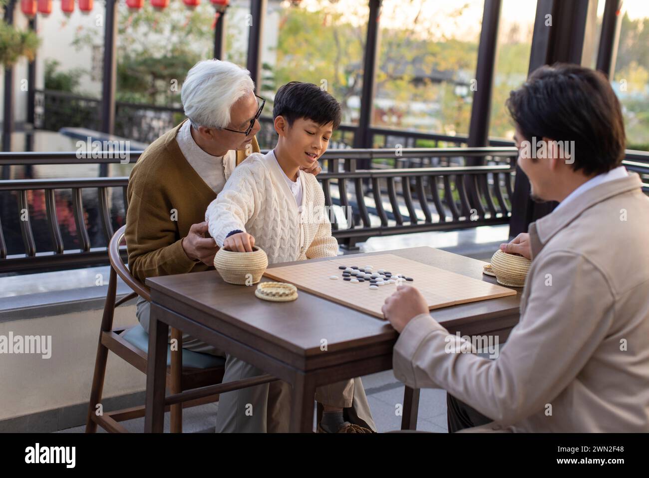 Family members sitting by table hi-res stock photography and images - Alamy