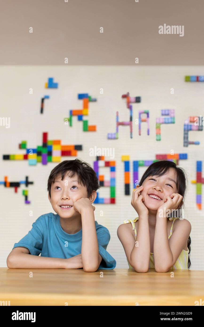 Cute children thinking in classroom Stock Photo - Alamy