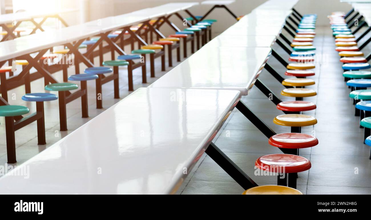 Clean school cafeteria with white tables and colorful seats Stock Photo ...