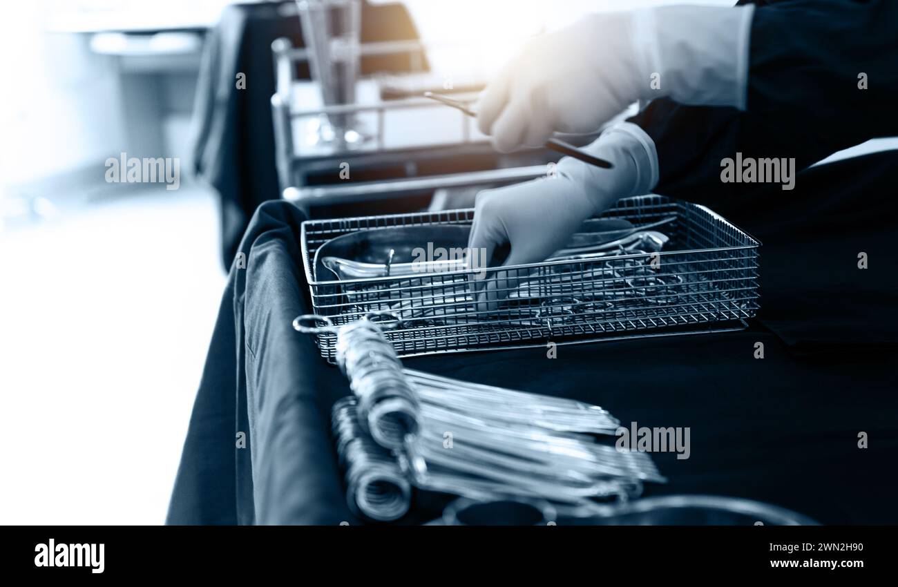 Medical instruments with surgeons hand Stock Photo - Alamy
