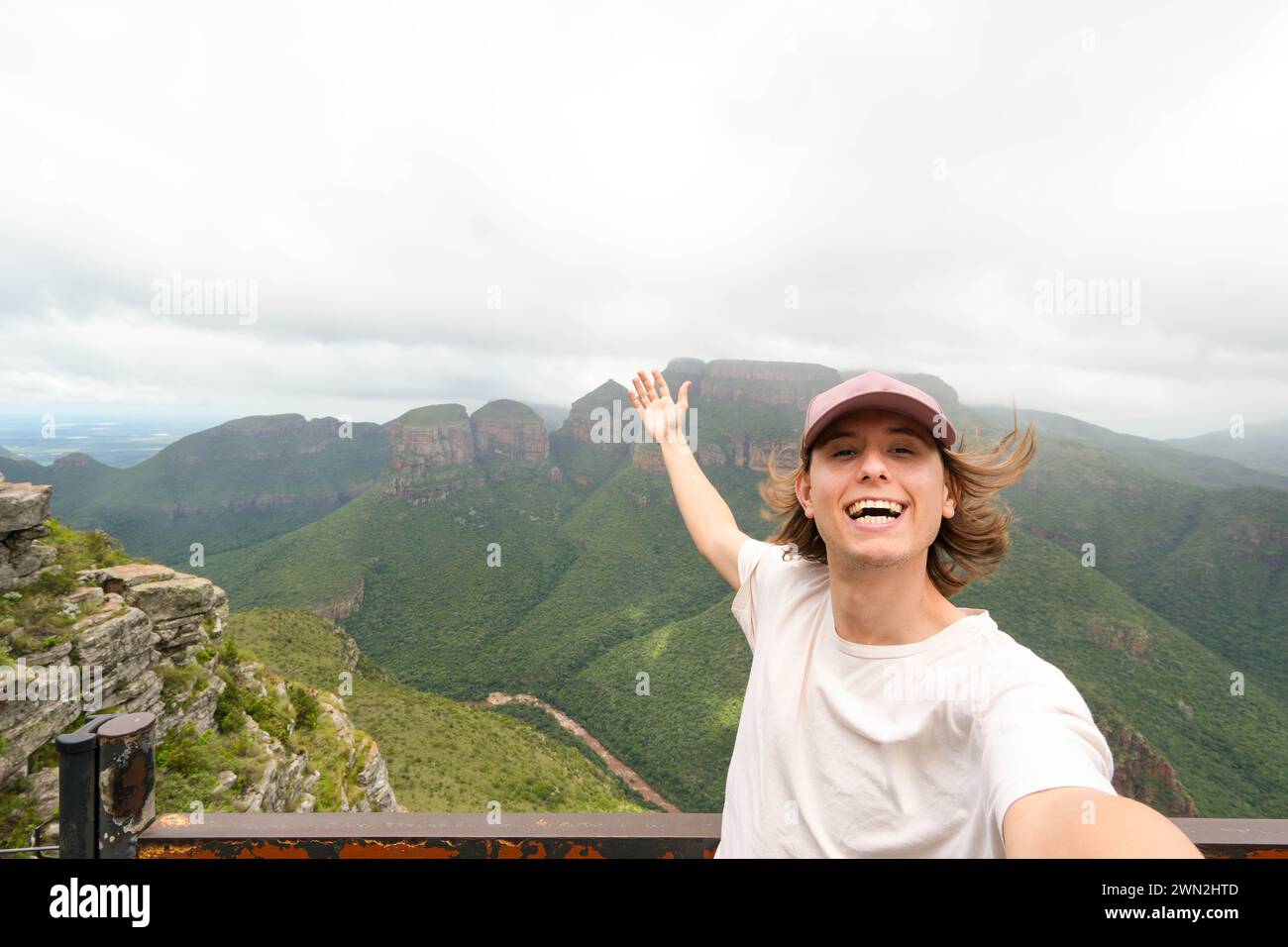 A cheerful young man captures a selfie with the breathtaking ...