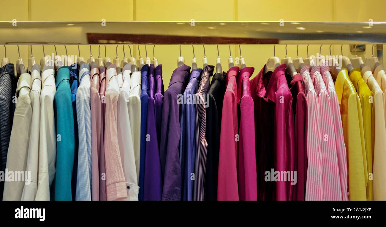 Collection of women's clothes hanging on rack Stock Photo - Alamy