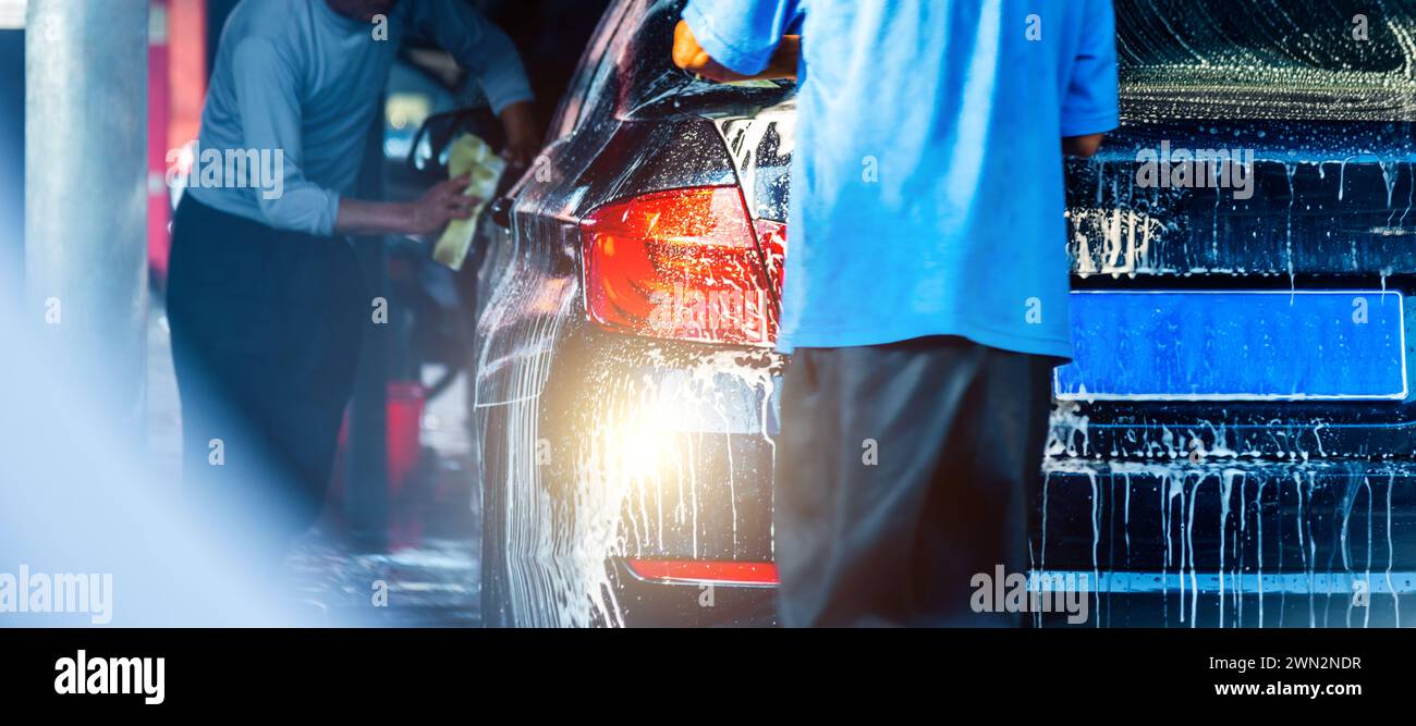 People washing car with flowing water and foam Stock Photo - Alamy