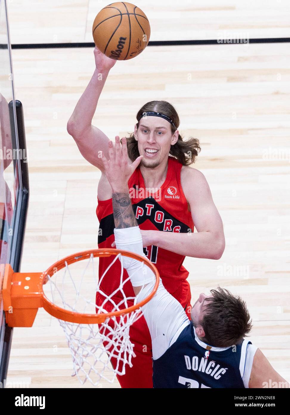 Toronto, Canada. 28th Feb, 2024. Kelly Olynyk (top) of Toronto Raptors ...