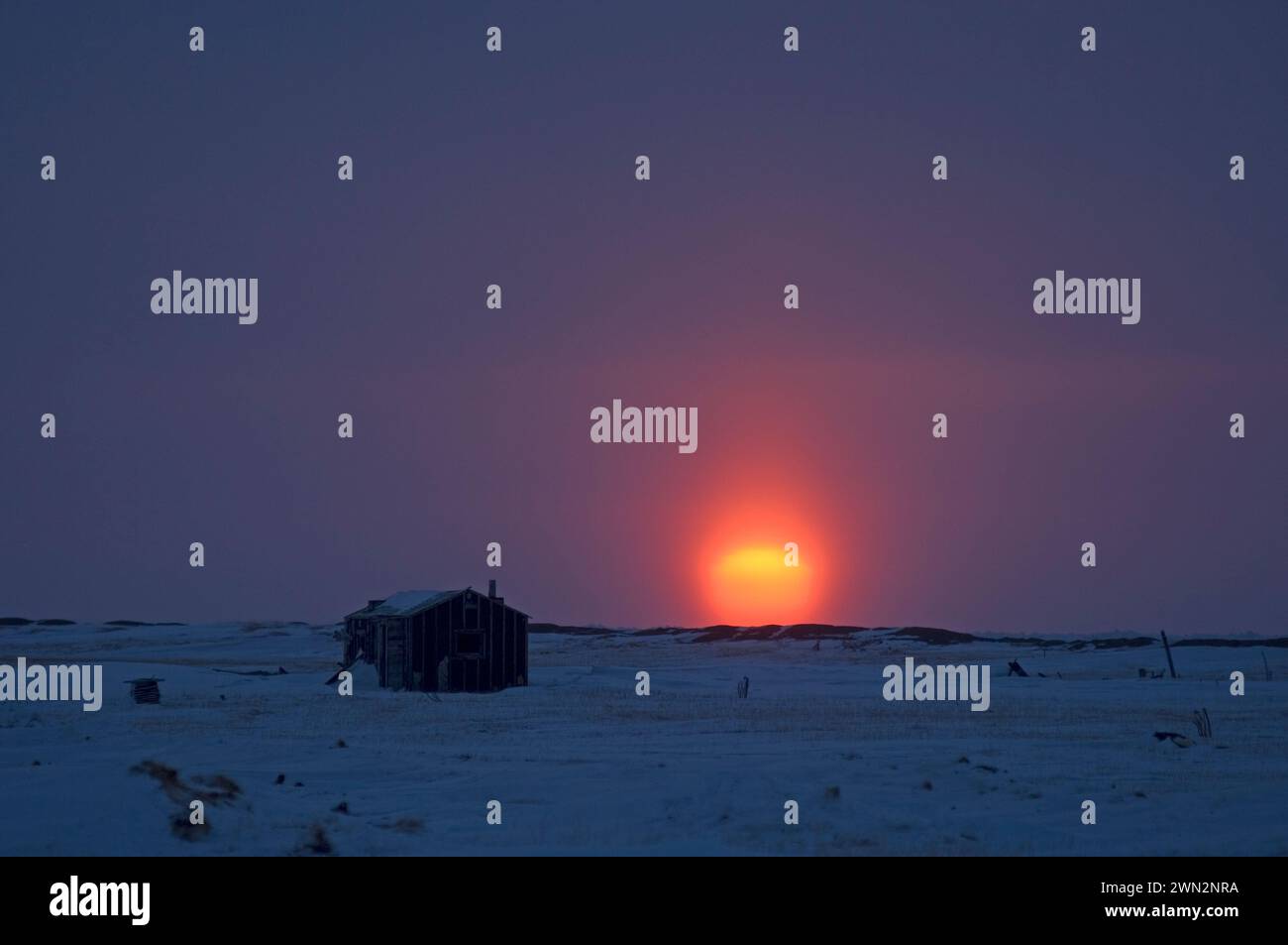 setting sun over old town site of village Point Hope northern coastline ...