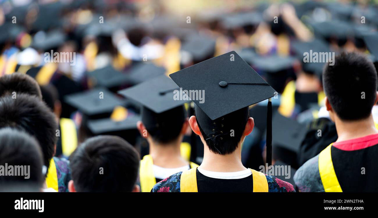 Back view of graduates during commencement Stock Photo - Alamy