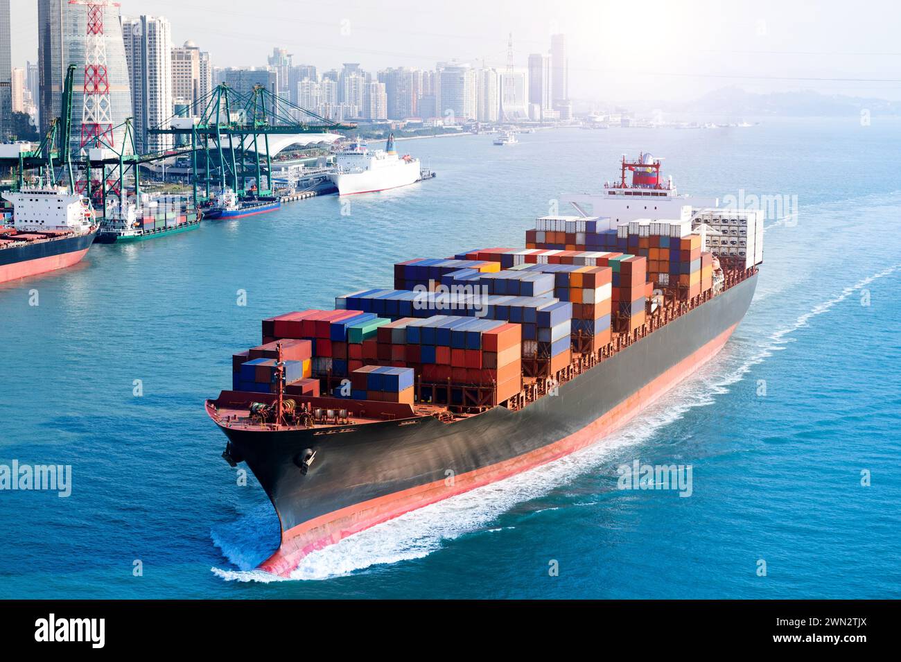 Large cargo container ship arriving in port Stock Photo - Alamy