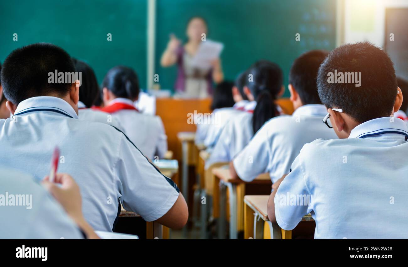 Rear view of students studying in classroom Stock Photo - Alamy