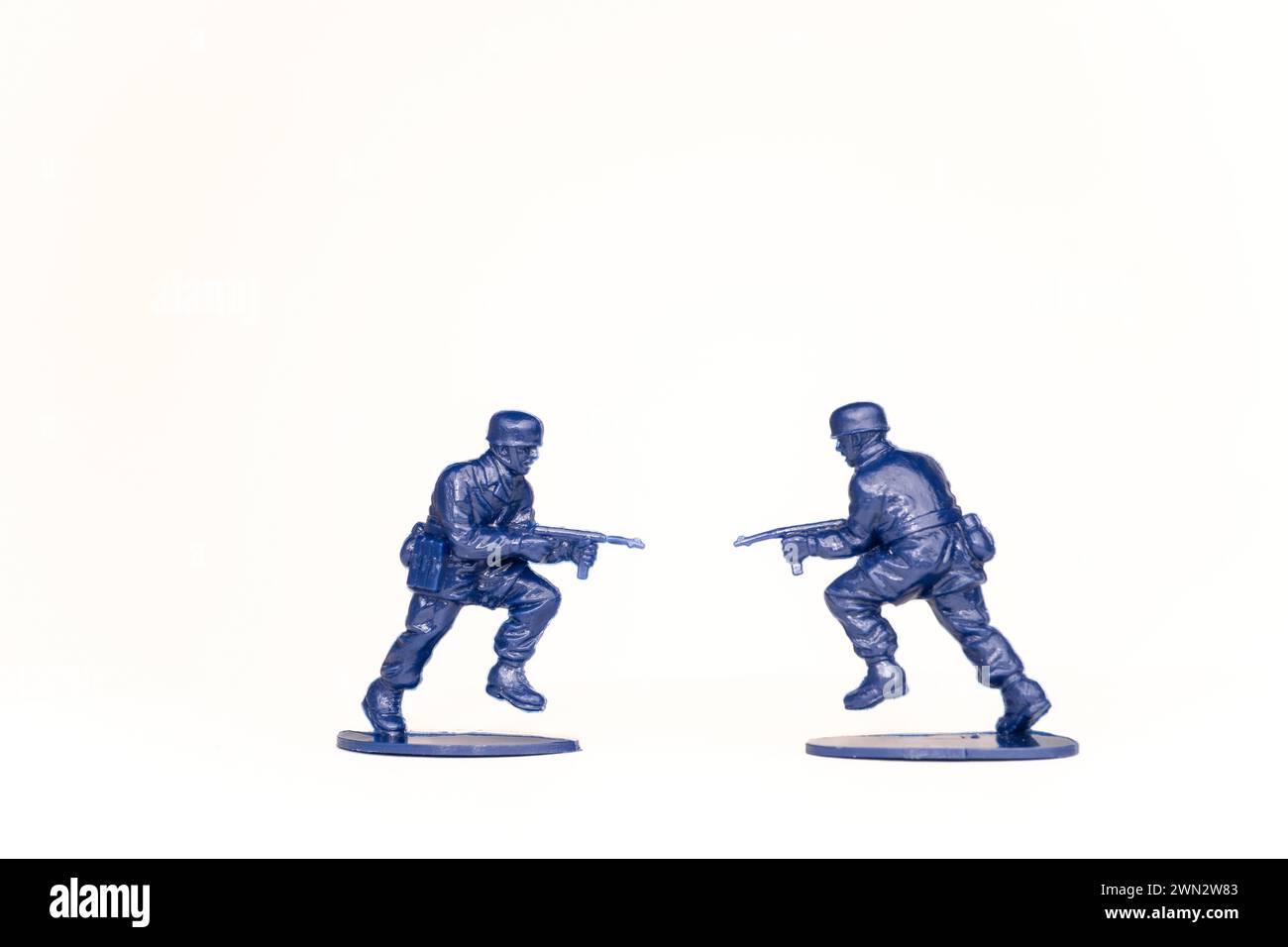 blue colored plastic soldiers on a white background. The war between ...