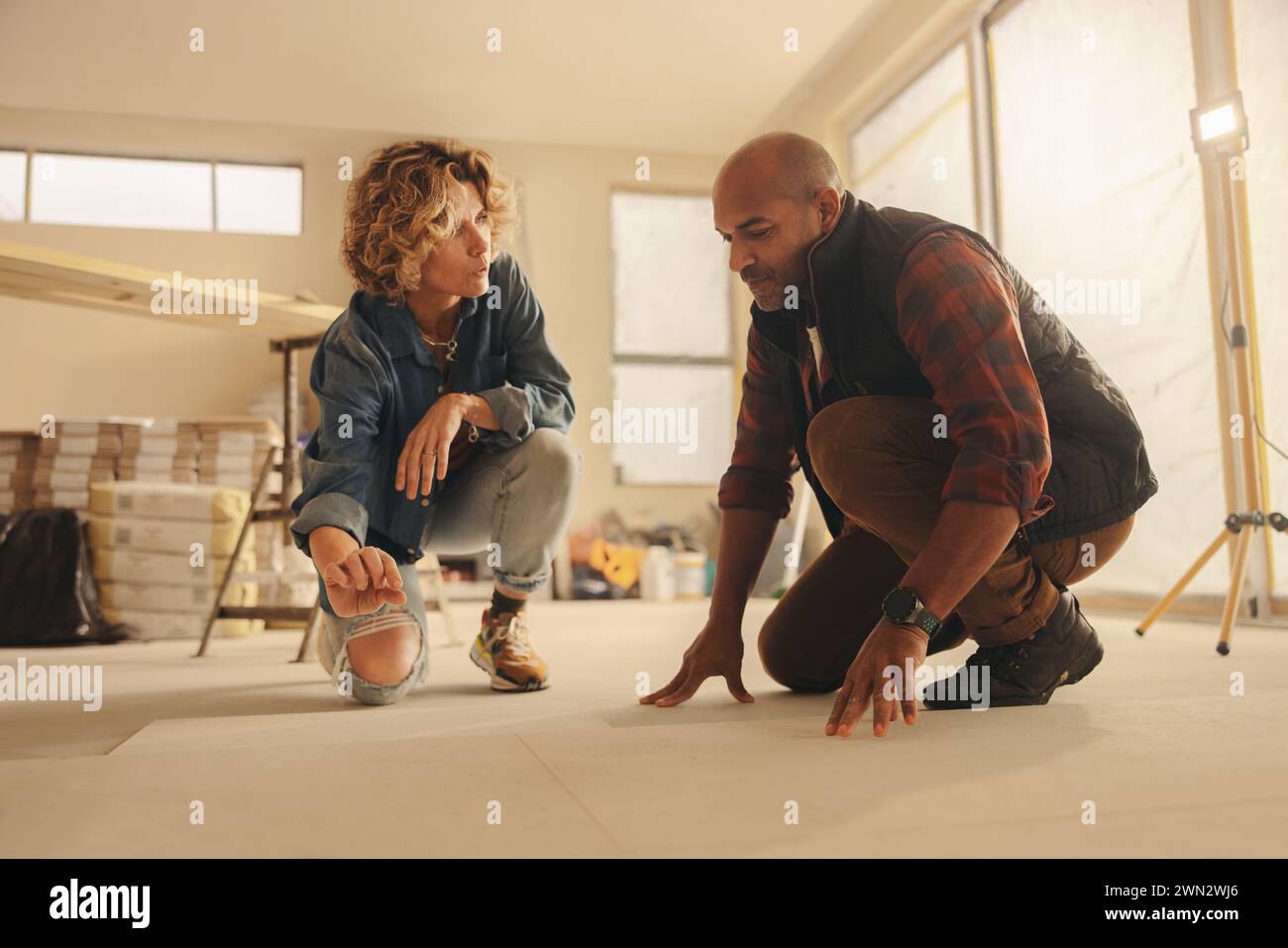 Man and woman discussing home renovation in their kitchen ...
