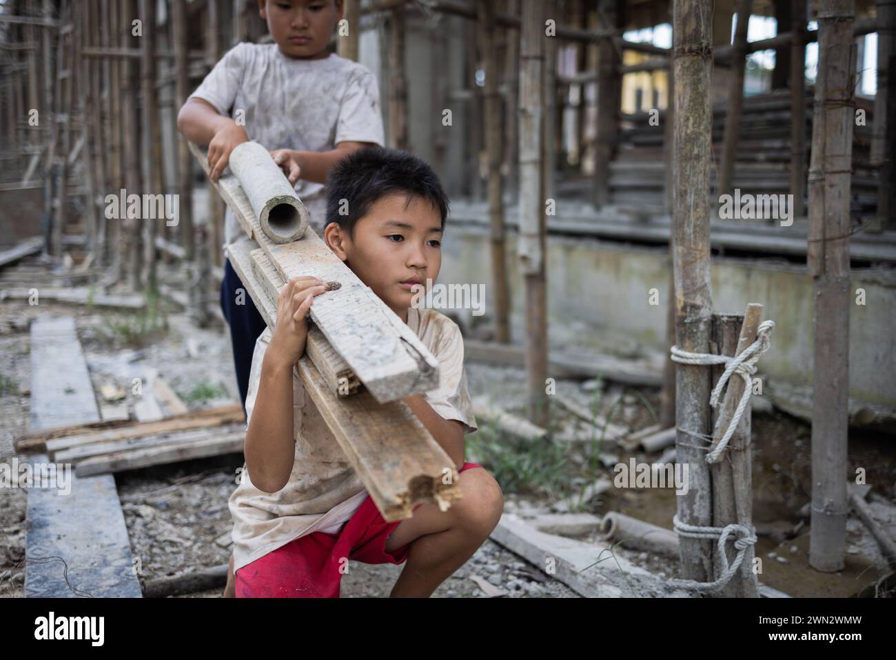 Poor boy working on a construction site. anti child labor Abuse ...