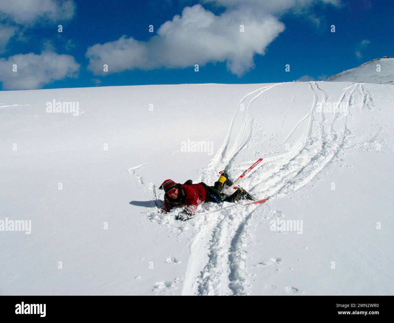 fall of a skier on the slope in a ski region in winter fall of a skier ...