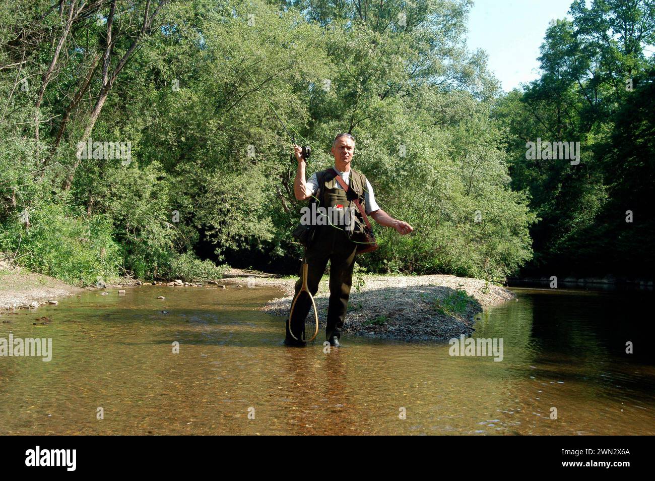 fly fishing in an alpine mountain stream, outdoor sports and activity ...