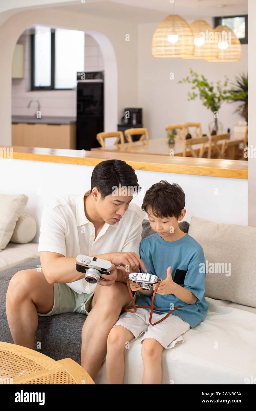 Happy father and son with cameras Stock Photo - Alamy