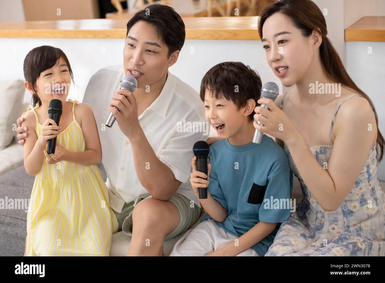 Happy family singing with microphones at home Stock Photo - Alamy