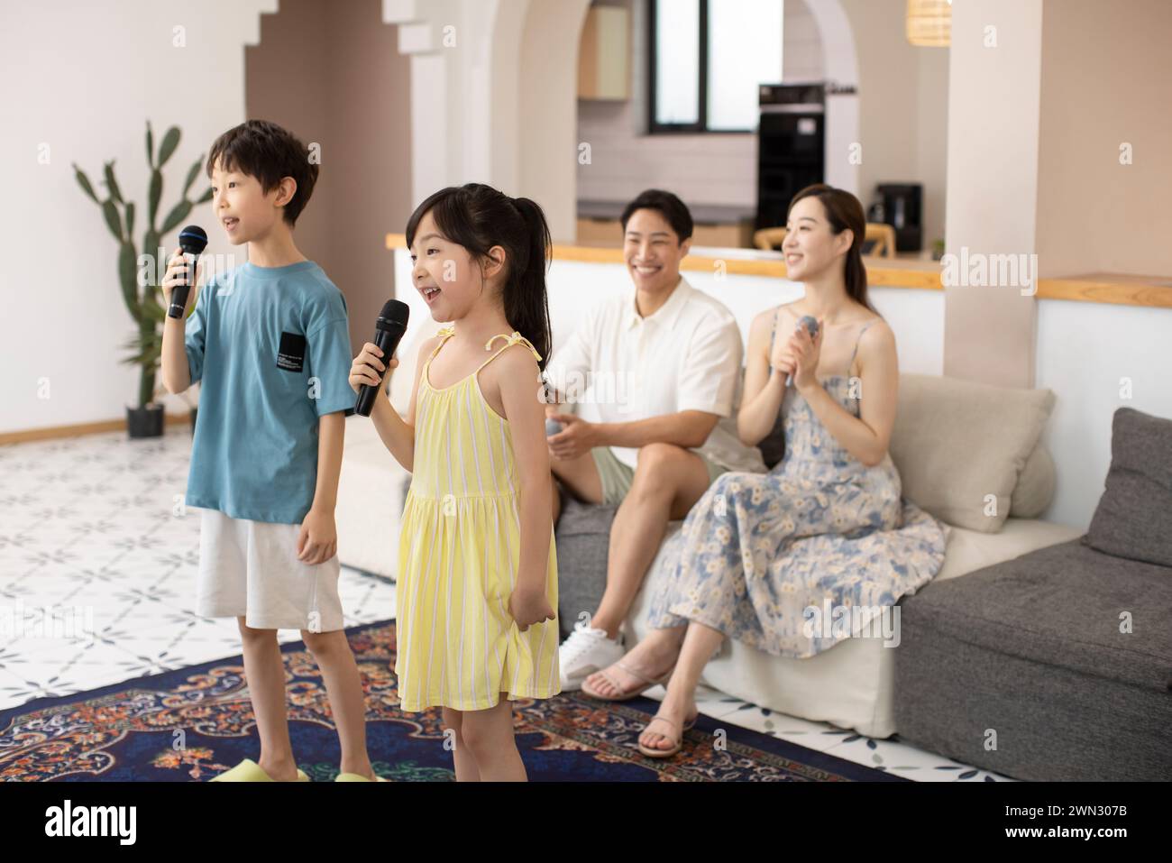Happy family singing with microphones at home Stock Photo - Alamy