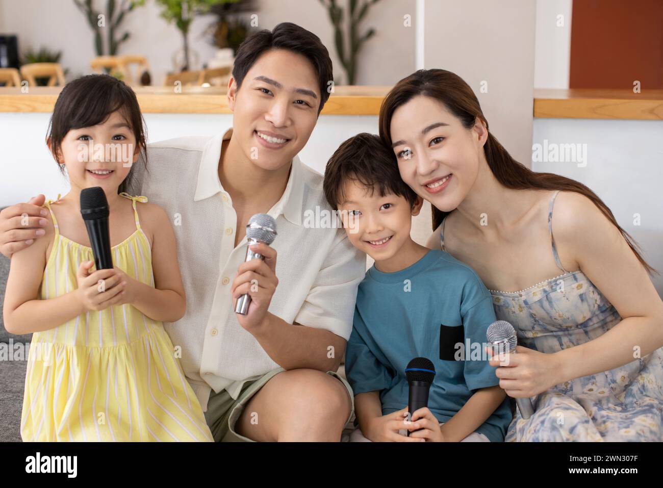 Happy family singing with microphones at home Stock Photo - Alamy