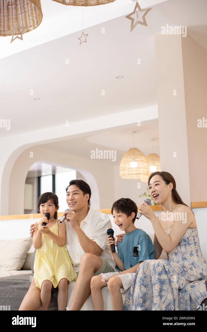 Happy family singing with microphones at home Stock Photo - Alamy