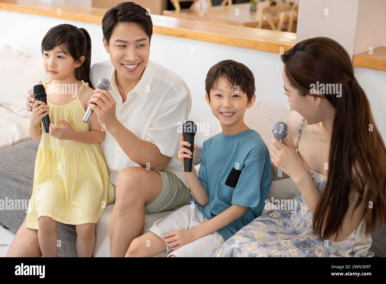 Happy family singing with microphones at home Stock Photo - Alamy