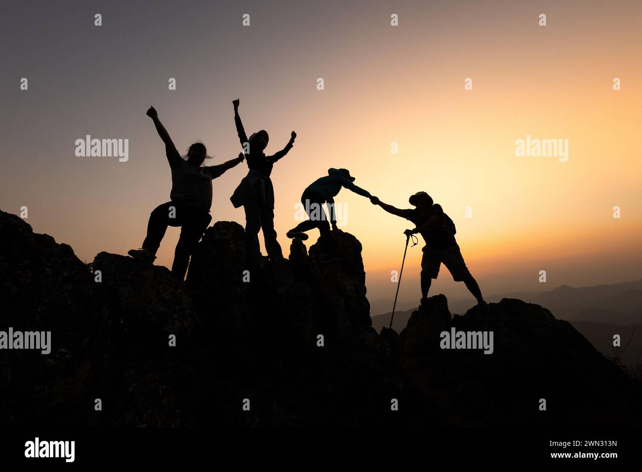 Sunset tourists climb mountain overcoming hi-res stock photography and ...