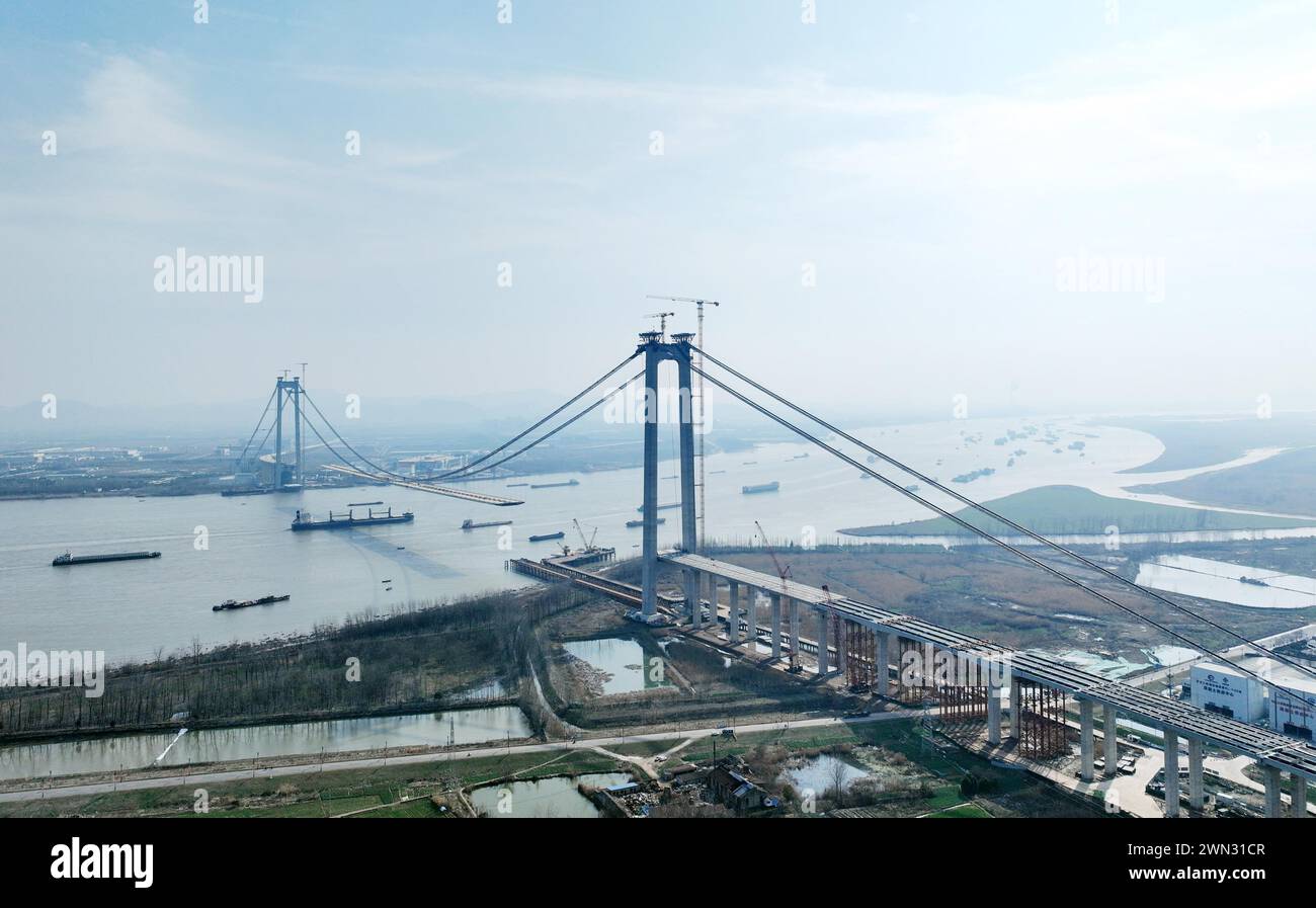 Aerial photo shows the Longtan Yangtze River Bridge under construction ...