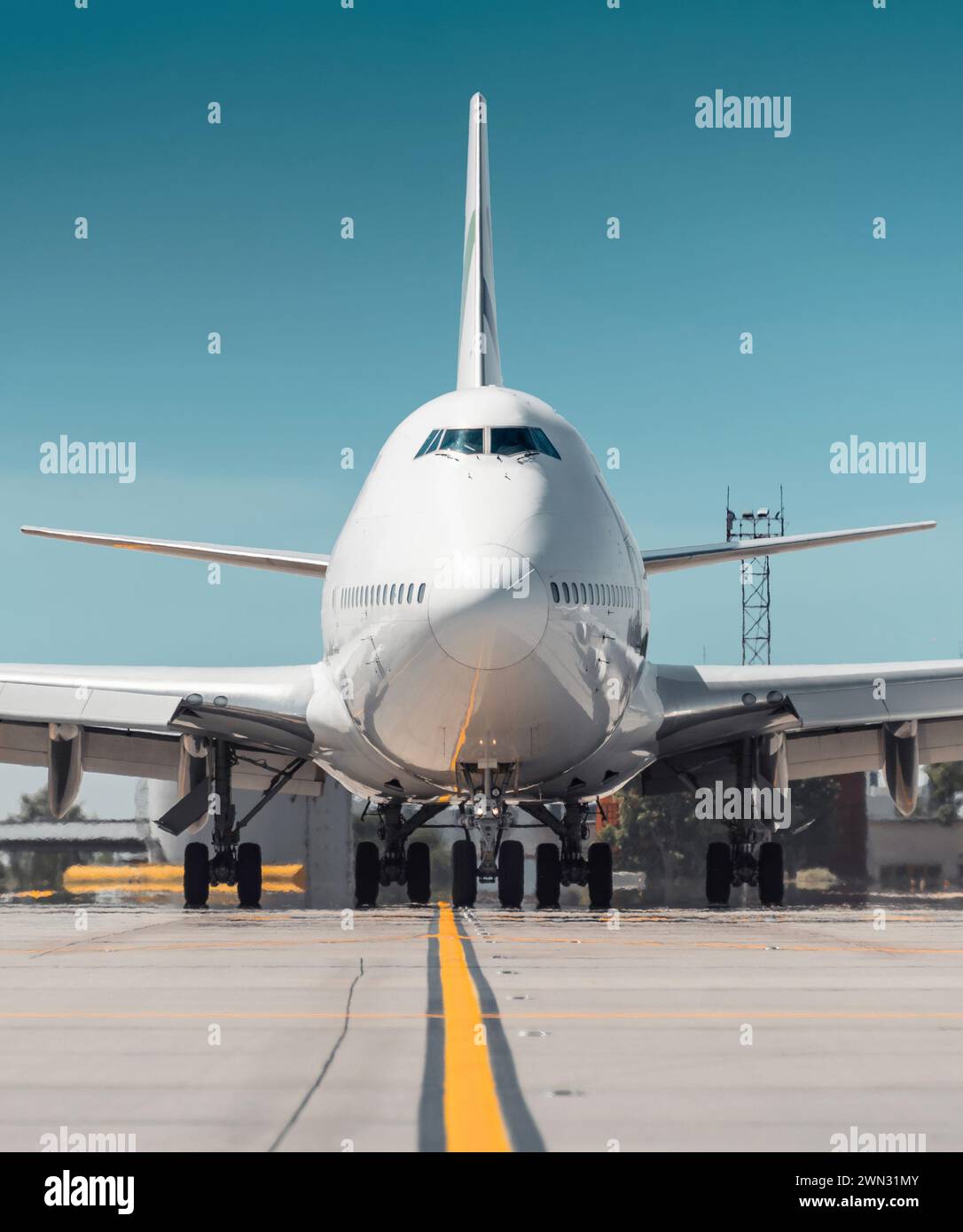 Huge white passenger aircraft taxiing, hot exhaust coming out of the ...