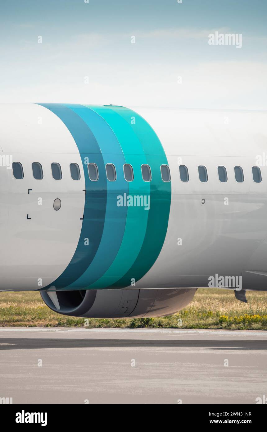 Vertical image of fuselage section with four blue-teal colored rings ...