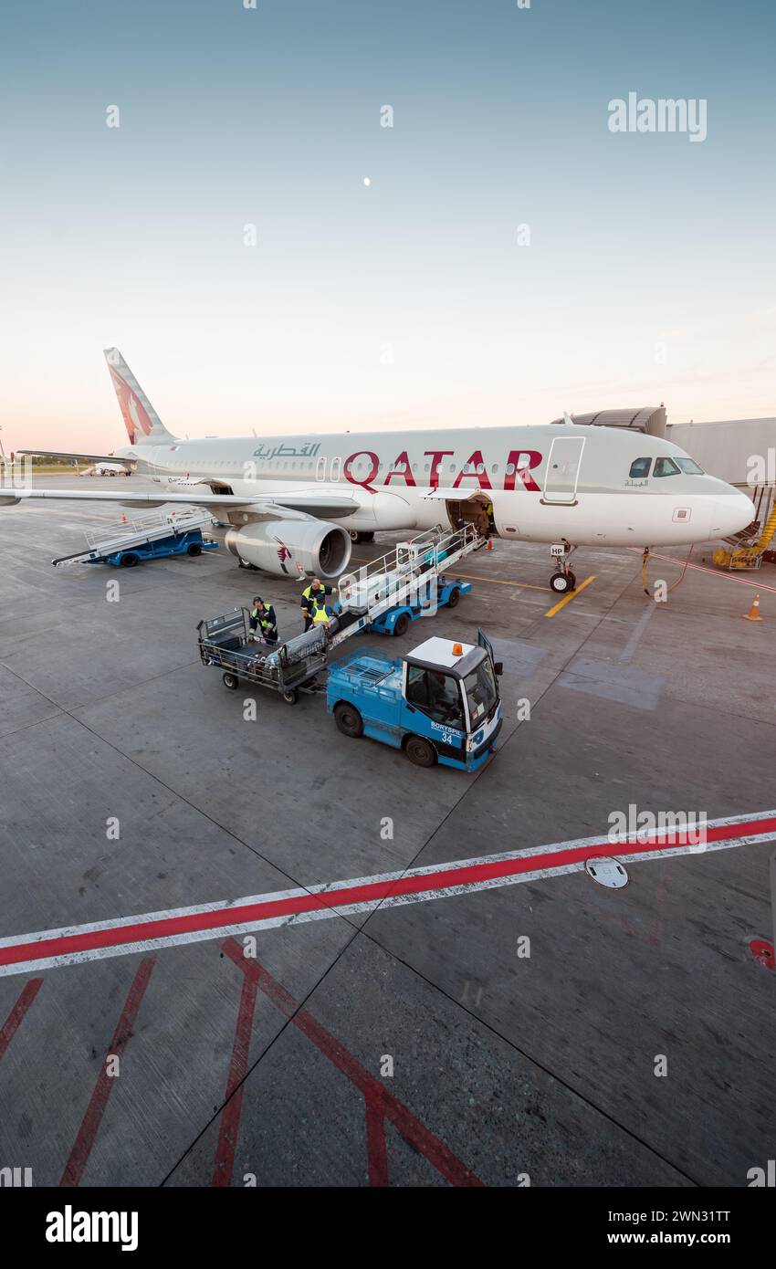 Qatar Airways aircraft at jet bridge near teminal gate. Qatar Airways ...