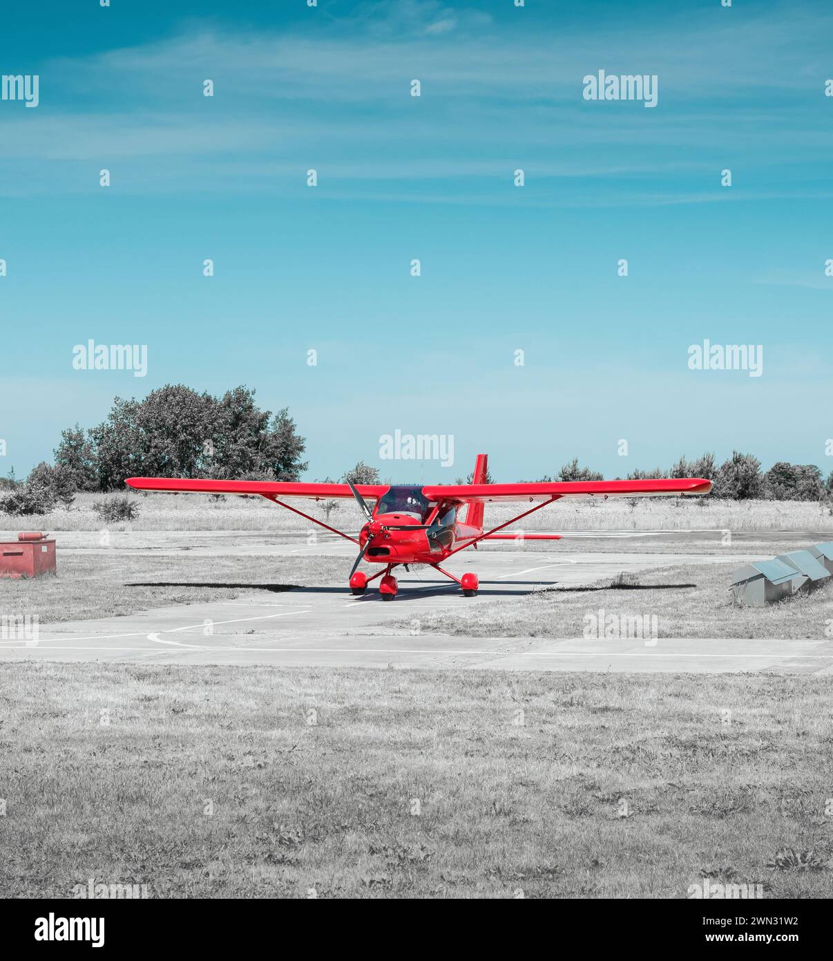 red ultralight propeller aircraft Aeroprakt on taxiway. Small plane on ...