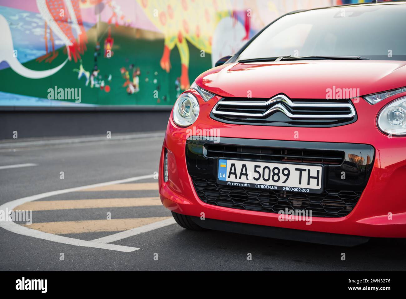 close up view of red Citroen C1: front bumper and headlight in focus ...