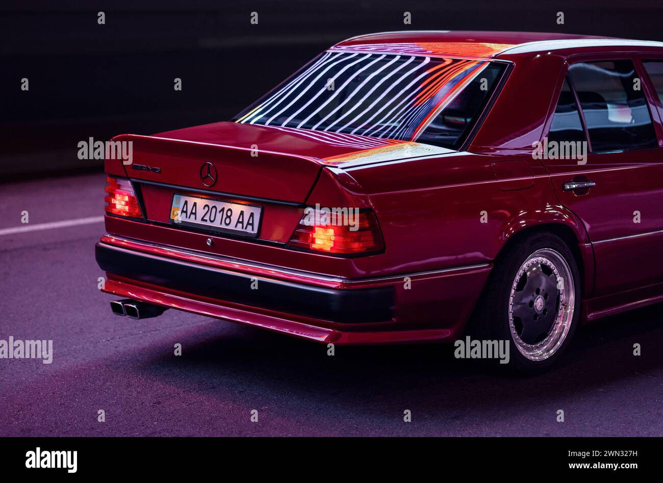 Rear three quarter view of Mercedes-Benz 400E (W124) in AMG body kit at ...
