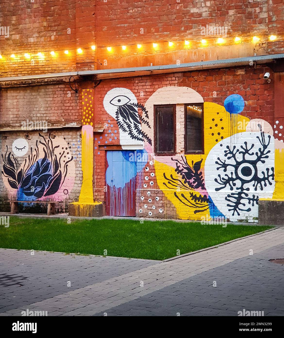 street art on the wall of old factory. brick factory facade with ...