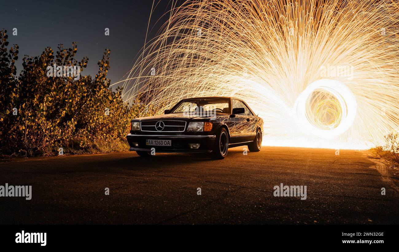 spinning steel wool behind classic Mercedes-Benz. Three quarter view of ...