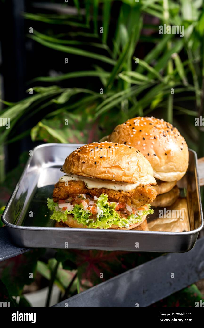 a tray of two burgers on the side of a balcony Stock Photo - Alamy