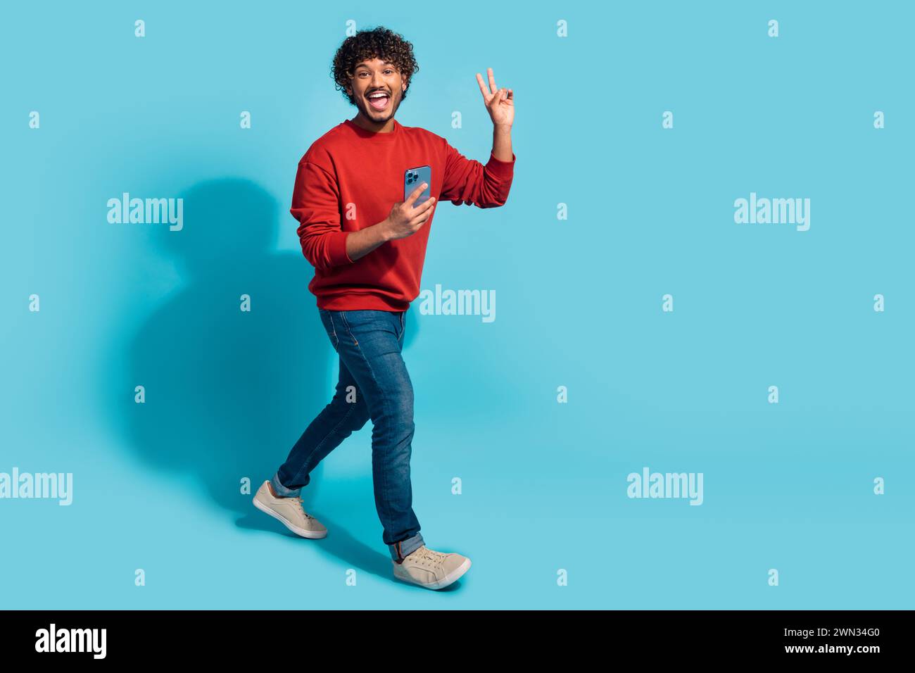 Full body size photo of funky indian arabian guy with modern cell phone ...