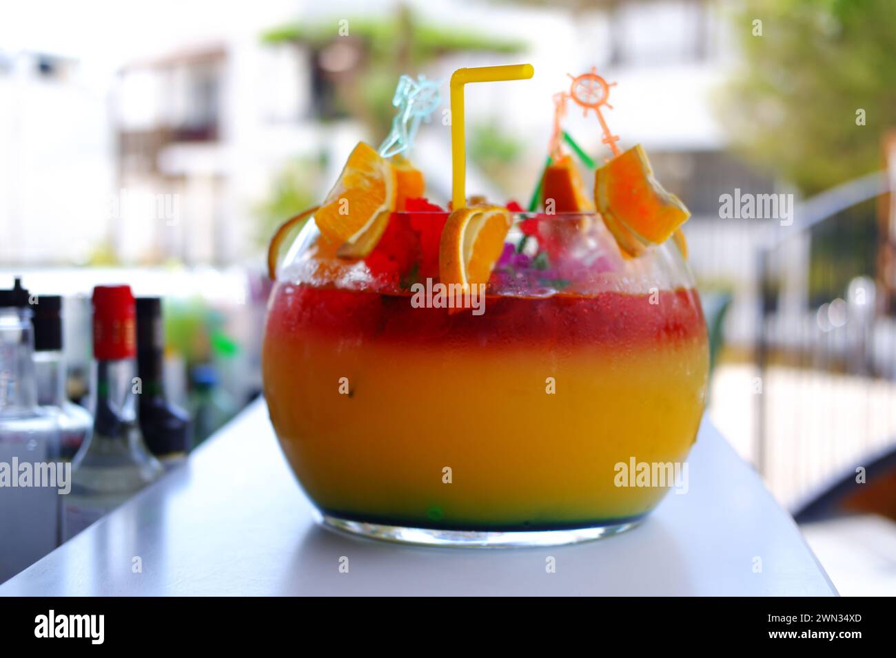 Big sphere glass for coctail outdoor on bar table in summer. Bokeh with ...