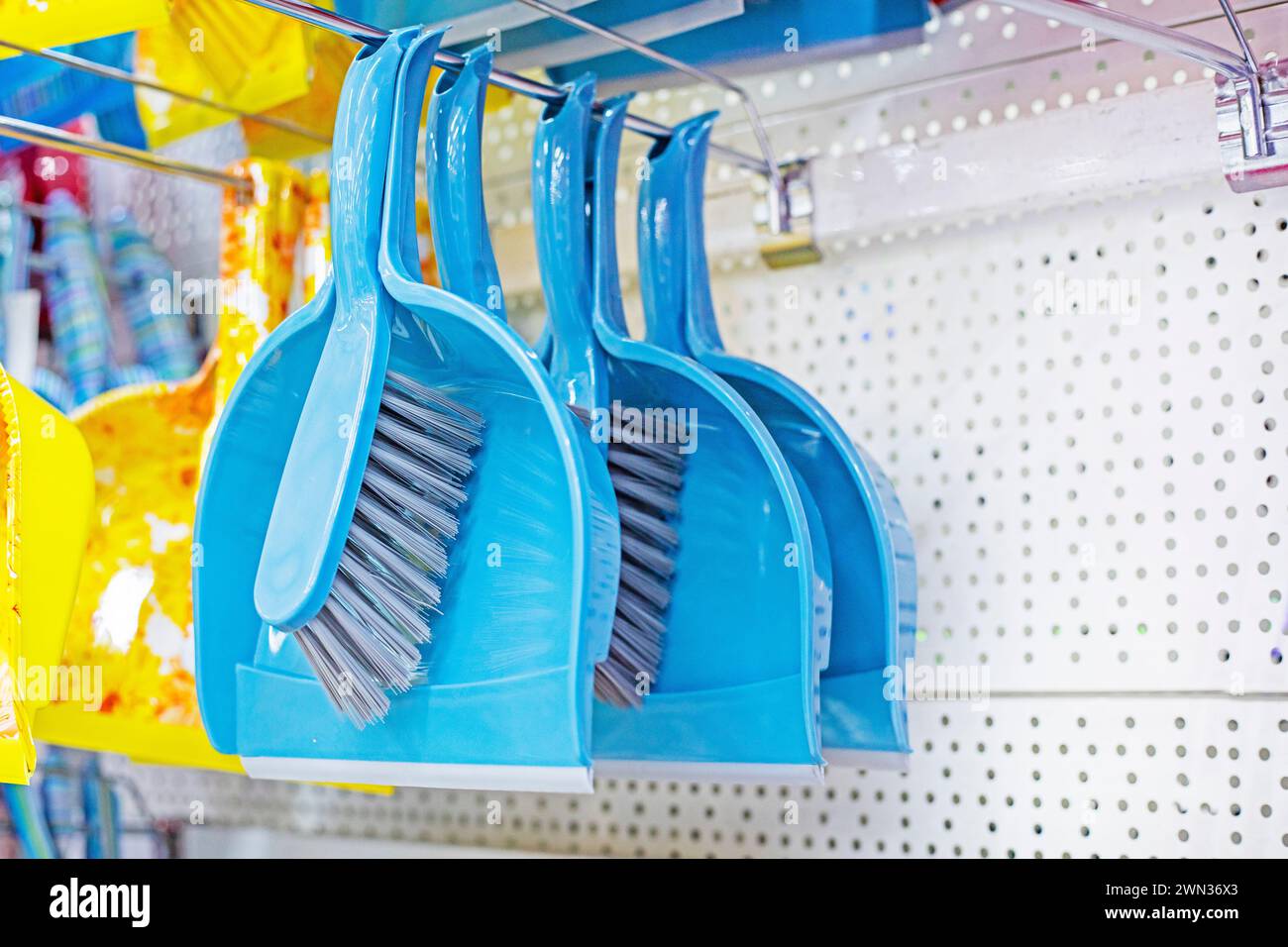 blue dustpan and broom sets for cleaning in a supermarket display case ...