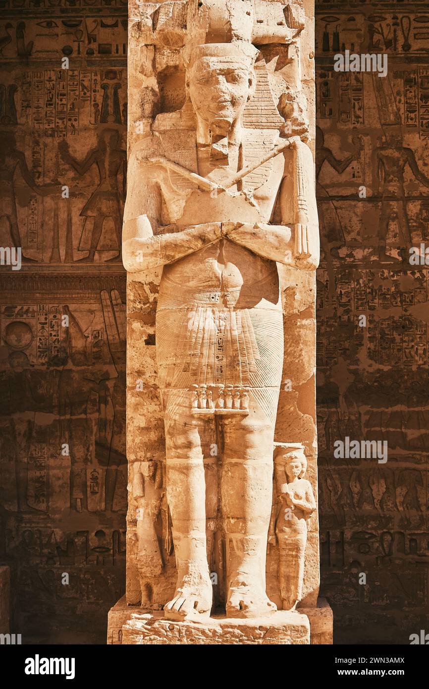 Sculpture of Pharaoh. Egyptian hieroglyphs in ancient temple. Popular ...