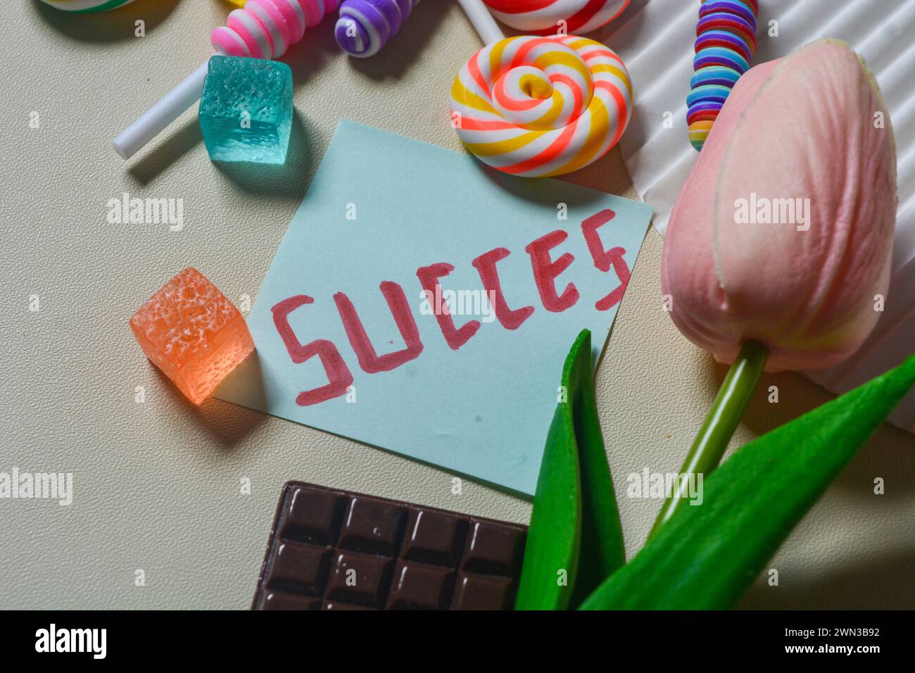Flat lay note with the word "WHY" on a background of candy, chocolate ...