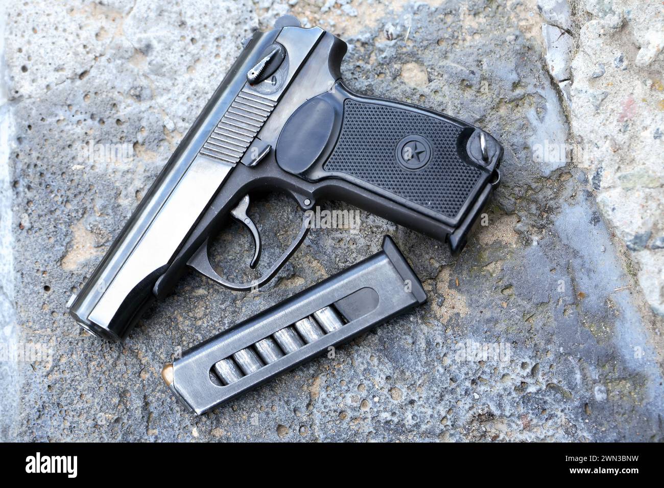 Handgun cartridge near pistol closeup on gray stone background Stock ...