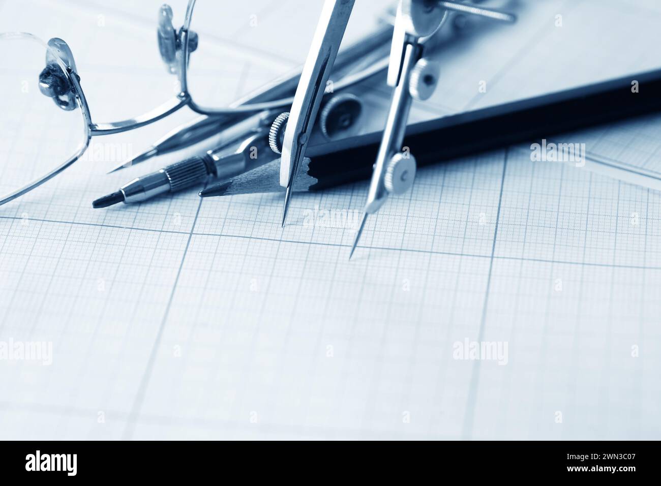 Set of old drawing tools on background with graph paper Stock Photo - Alamy