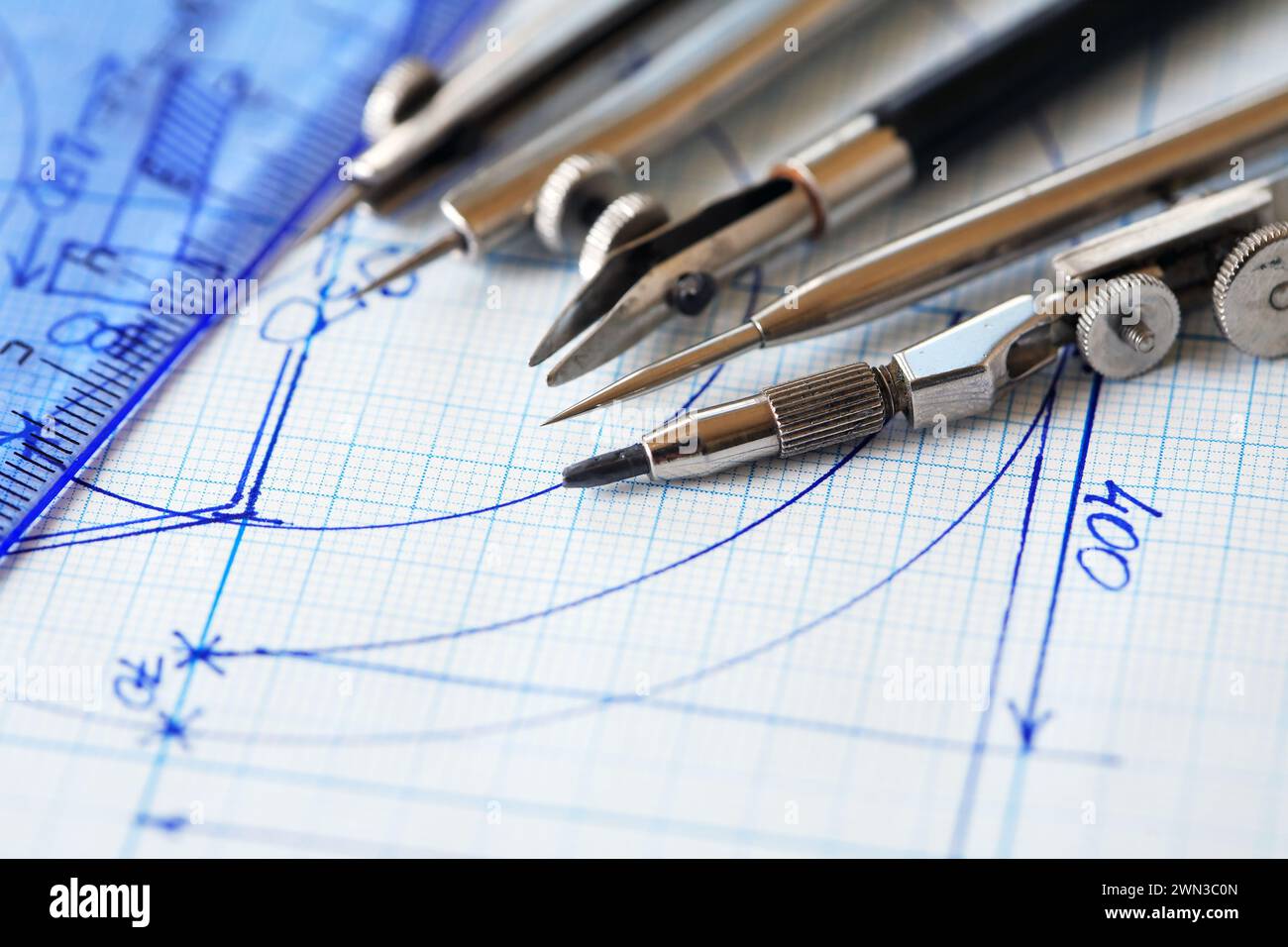 Set of old drawing tools on background with graph paper Stock Photo - Alamy