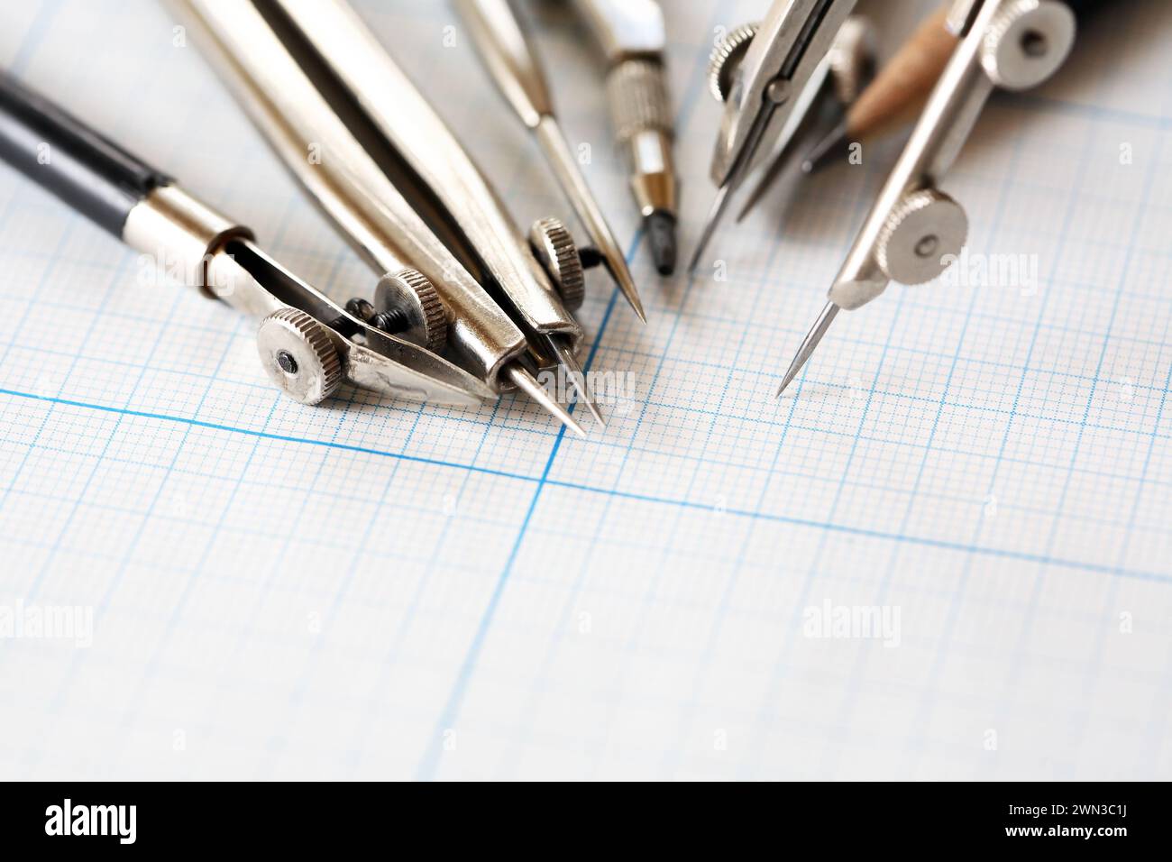 Set of old drawing tools on background with graph paper Stock Photo - Alamy