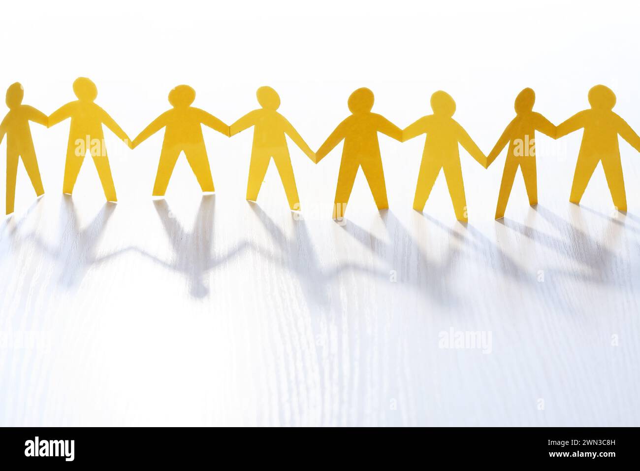 Handshake concept. Lot of men figures cutting from yellow paper in a ...