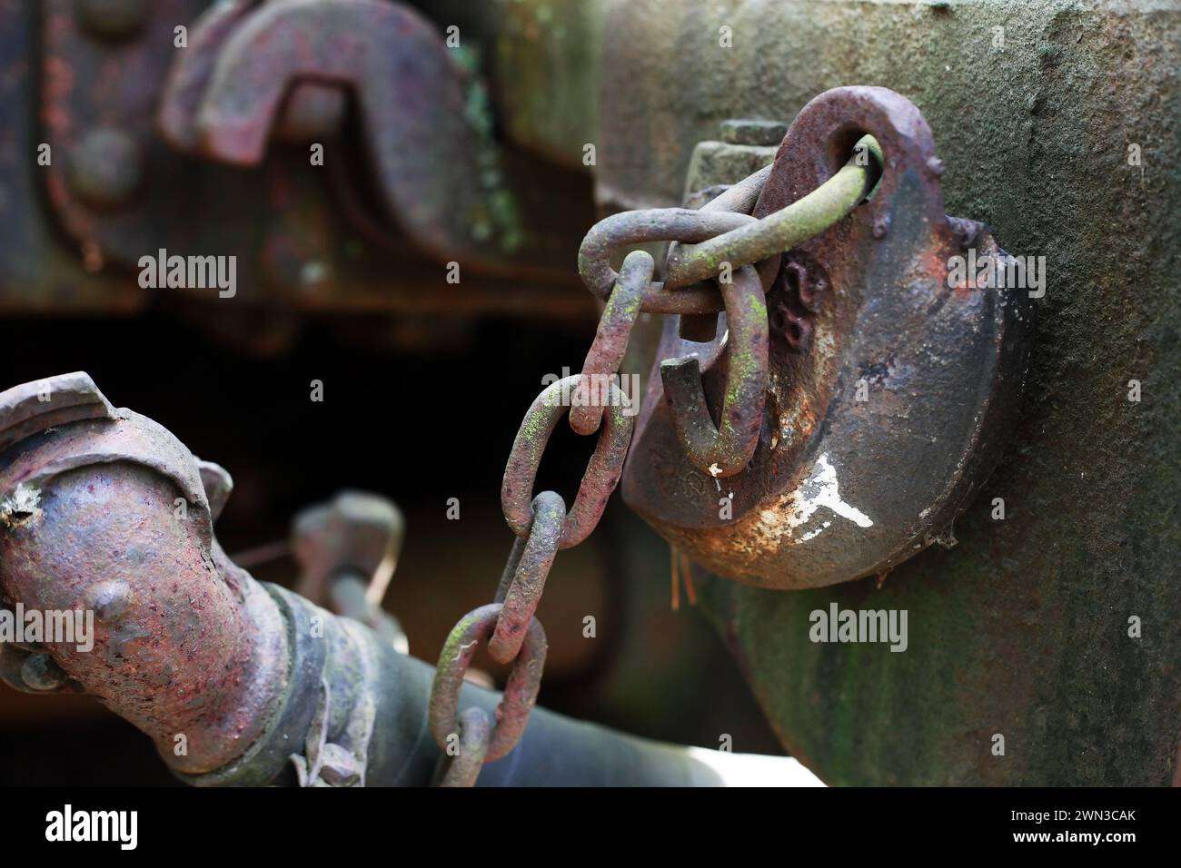An abandoned old railway carriage with rusty metal coupling closeup ...