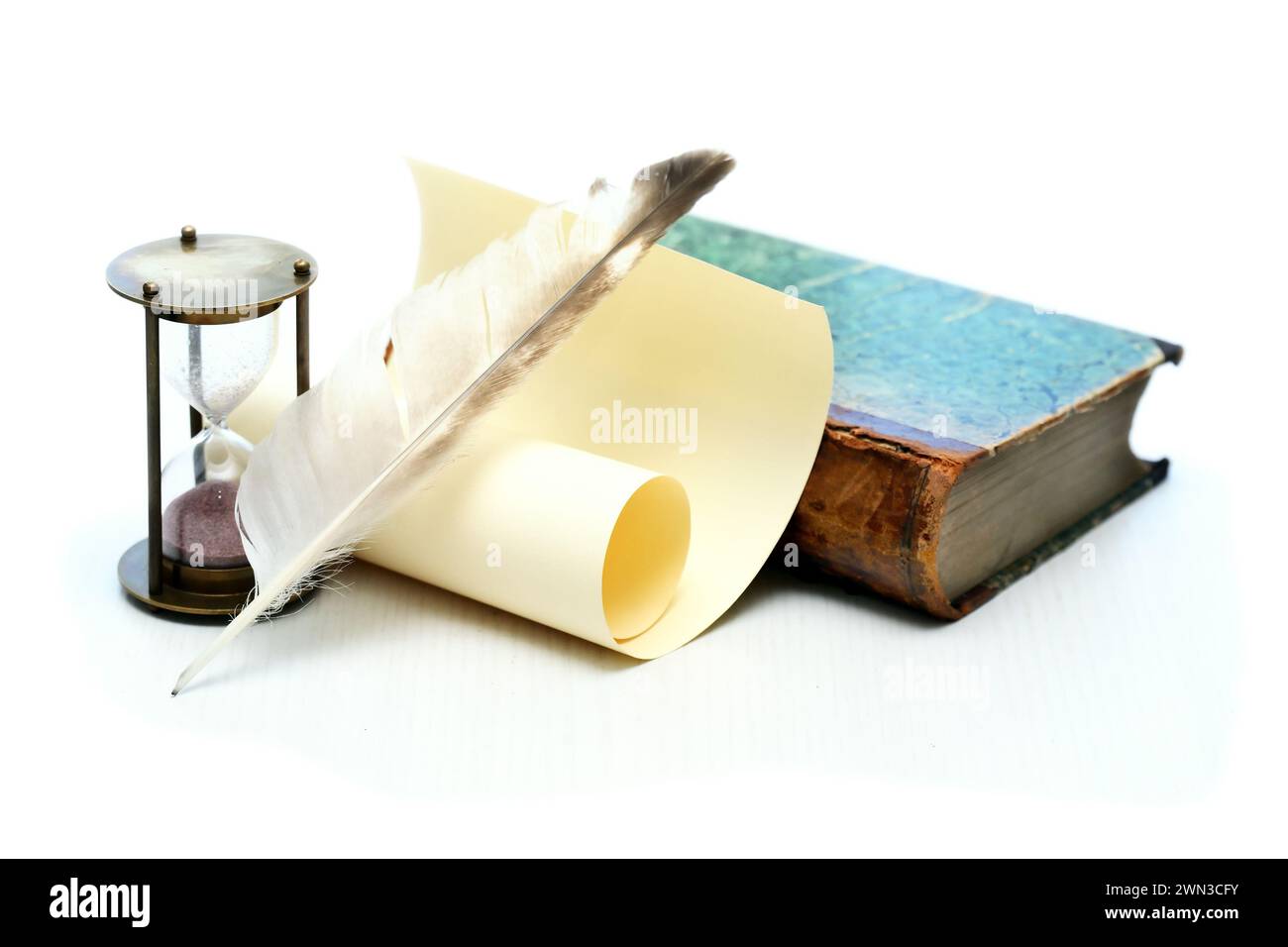 Vintage things. Quill and scroll near old book and hourglass Stock ...