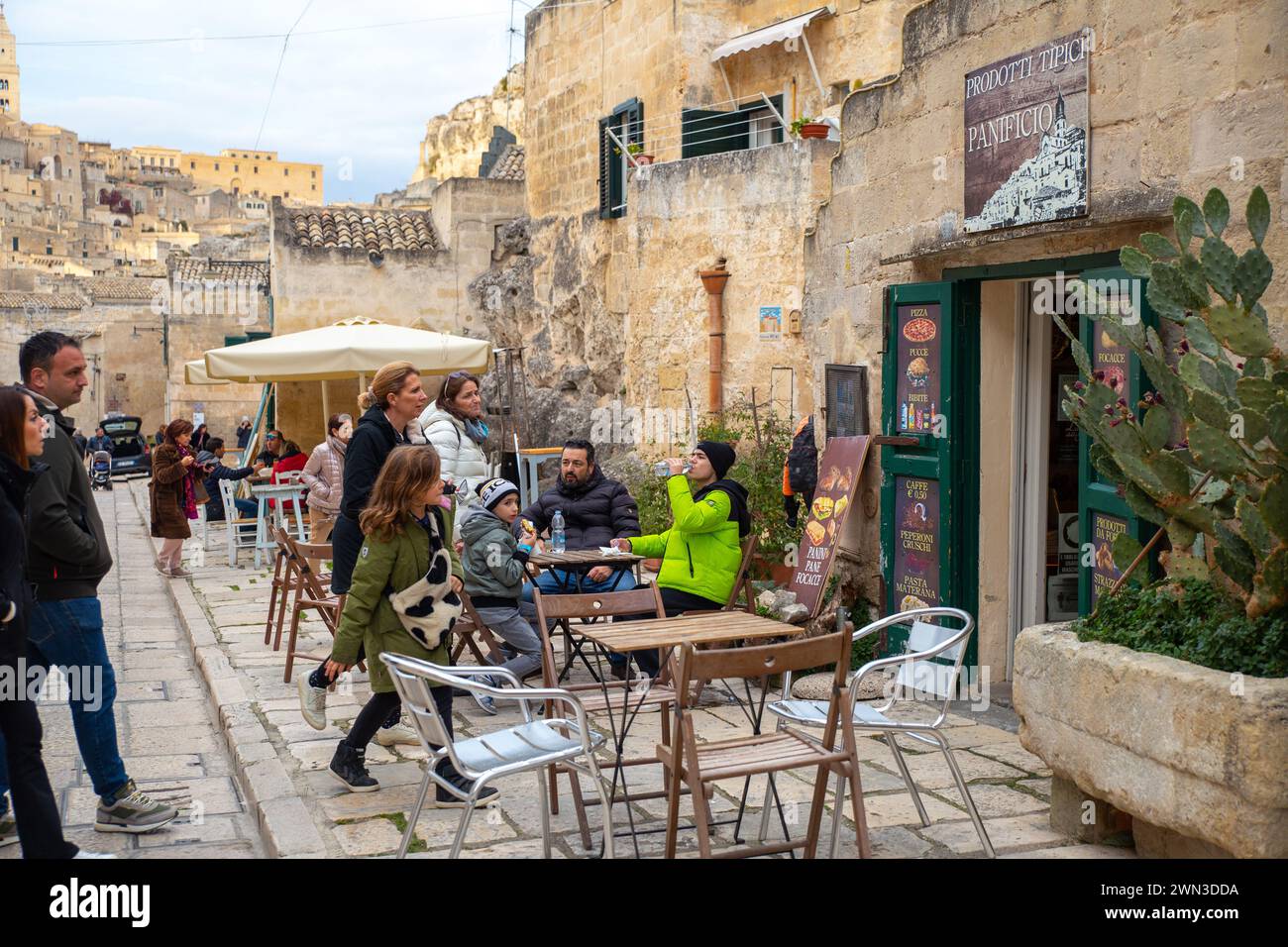 Matera, Italy–Dec 30, 2023: Tourists enjoy vacation in a cave bar Stock ...